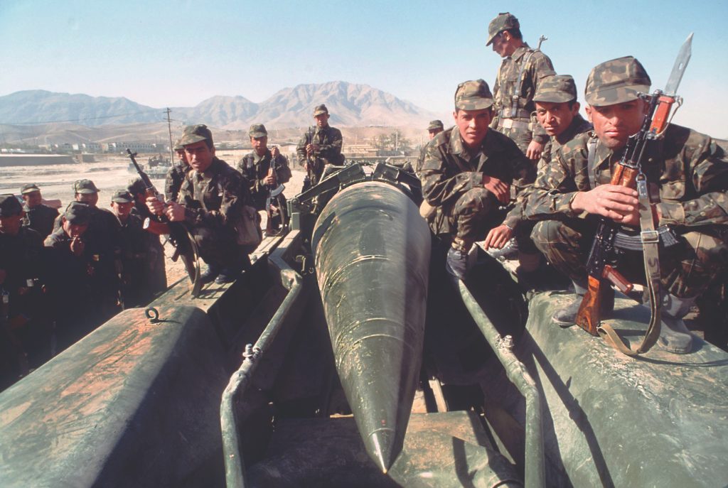 Afghan government troops pose aboard a Scud-B missile launcher provided ...
