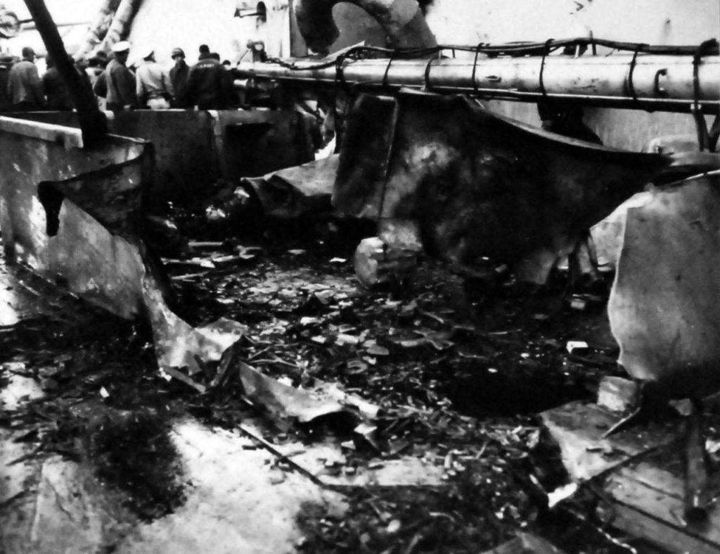 Damage to the USS Nevada’s deck following a kamikaze attack while off ...