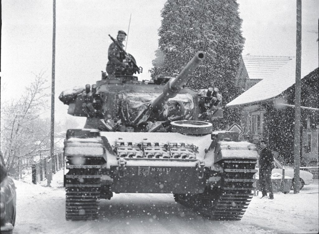 A British-made Swiss army Centurion tank negotiates city streets during ...